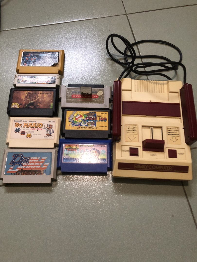 Vintage Nintendo Family Computer unit with game tapes, Video Gaming ...
